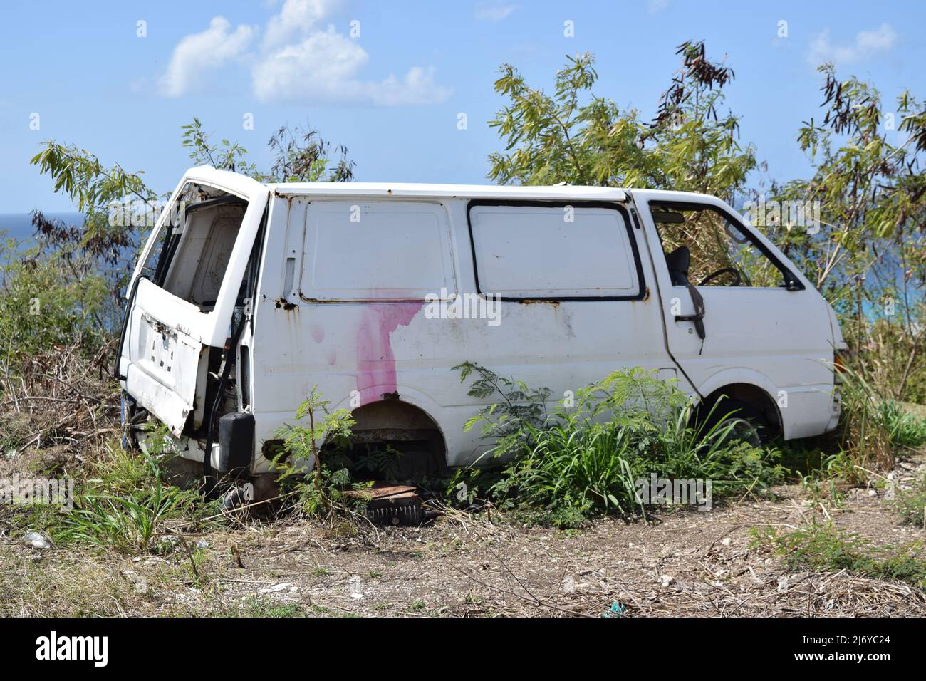 Abandoned white van in Barbados village Stock Photo - Alamy