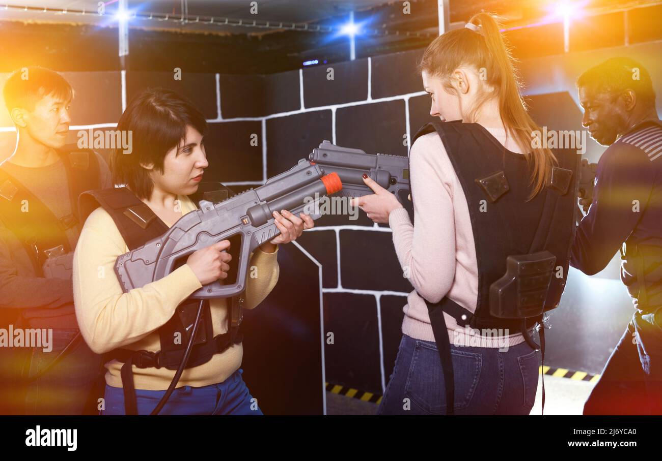 girls standing face to face with laser guns on lasertag gaming a Stock ...