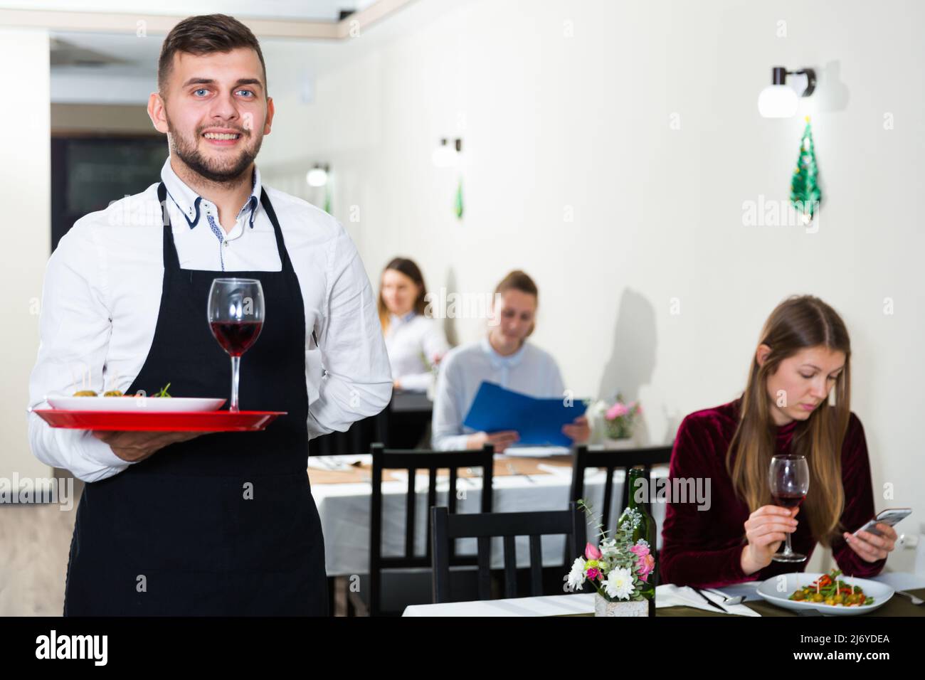 Portrait of waiter who is standing with dish in restaurante Stock Photo ...