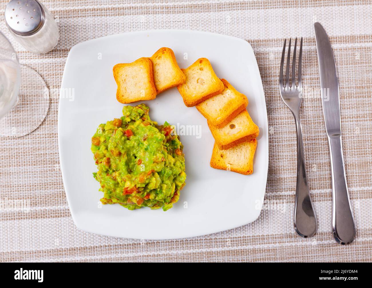 Guacamole dip served with toasted bread Stock Photo - Alamy