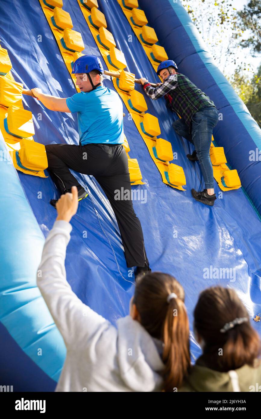 Friends having fun passing obstacle course Stock Photo - Alamy