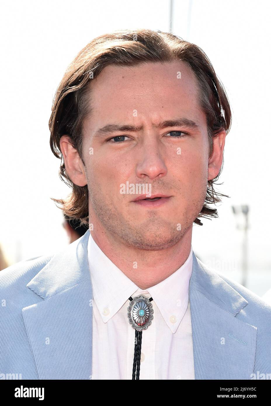 Lewis Pullman walking on the red carpet at the global premiere of "Top ...