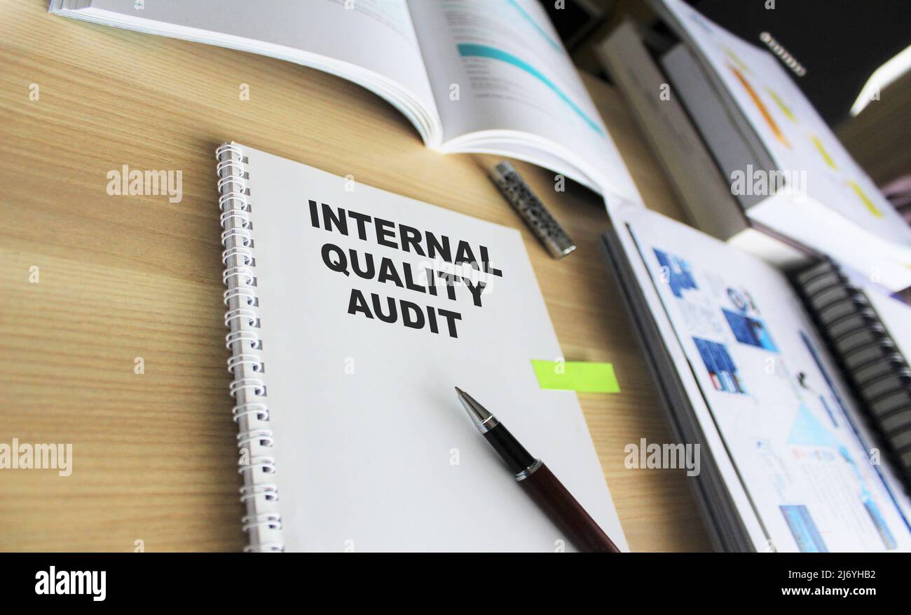 Internal audit word on working paper with pen. Business improvement ...