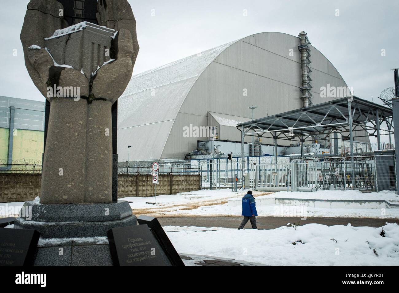 A Chernobyl nuclear power plant worker walks in front of the new ...