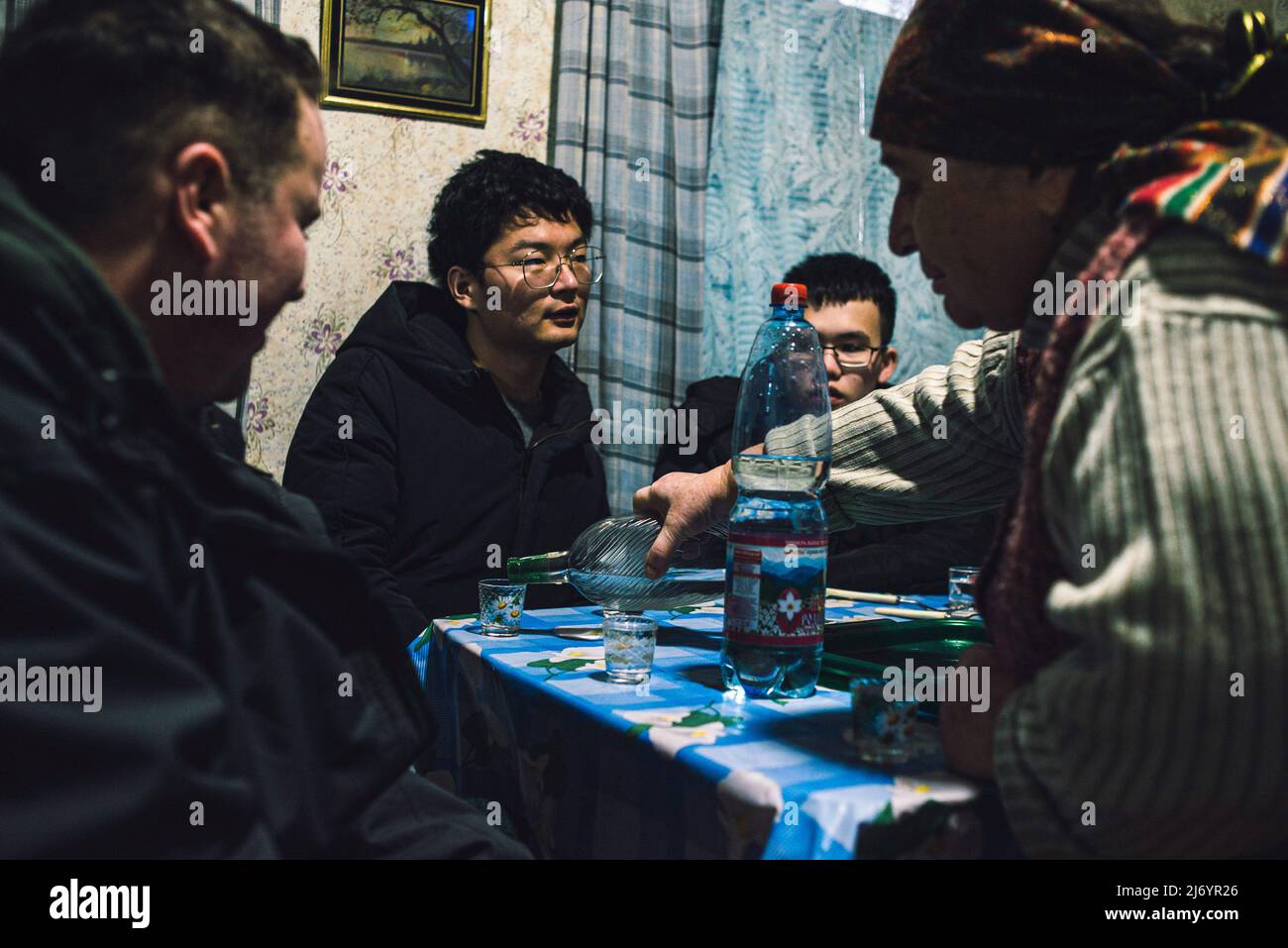 An elderly Chernobyl resident serves vodka to tourists in the exclusion ...