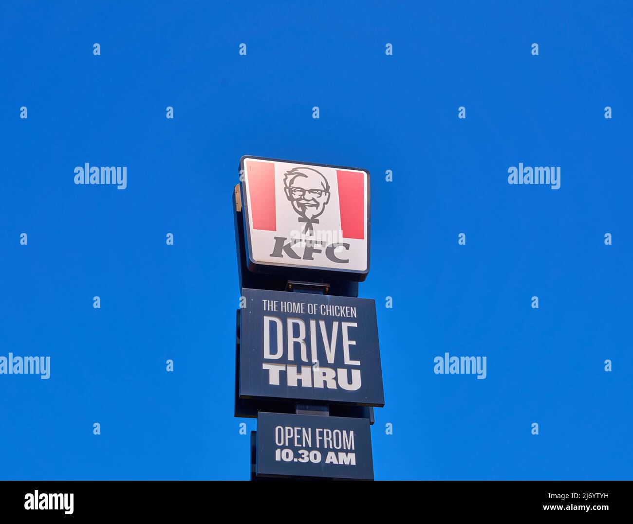 KFC drive thru sign against a clear blue sky Stock Photo - Alamy