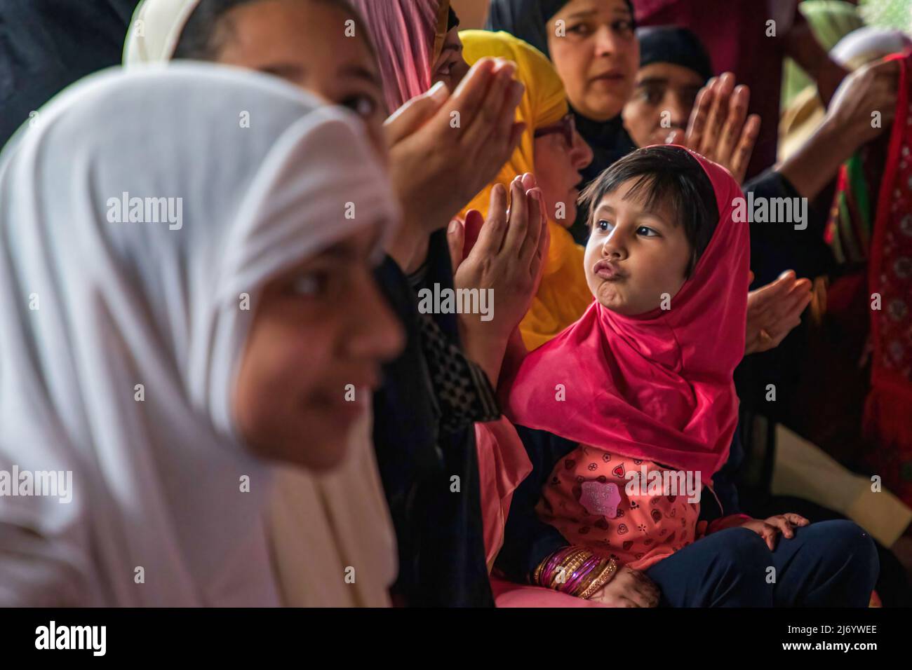 Kashmiri Muslim girl looks as women offering prayers during Eid-al-Fitr ...