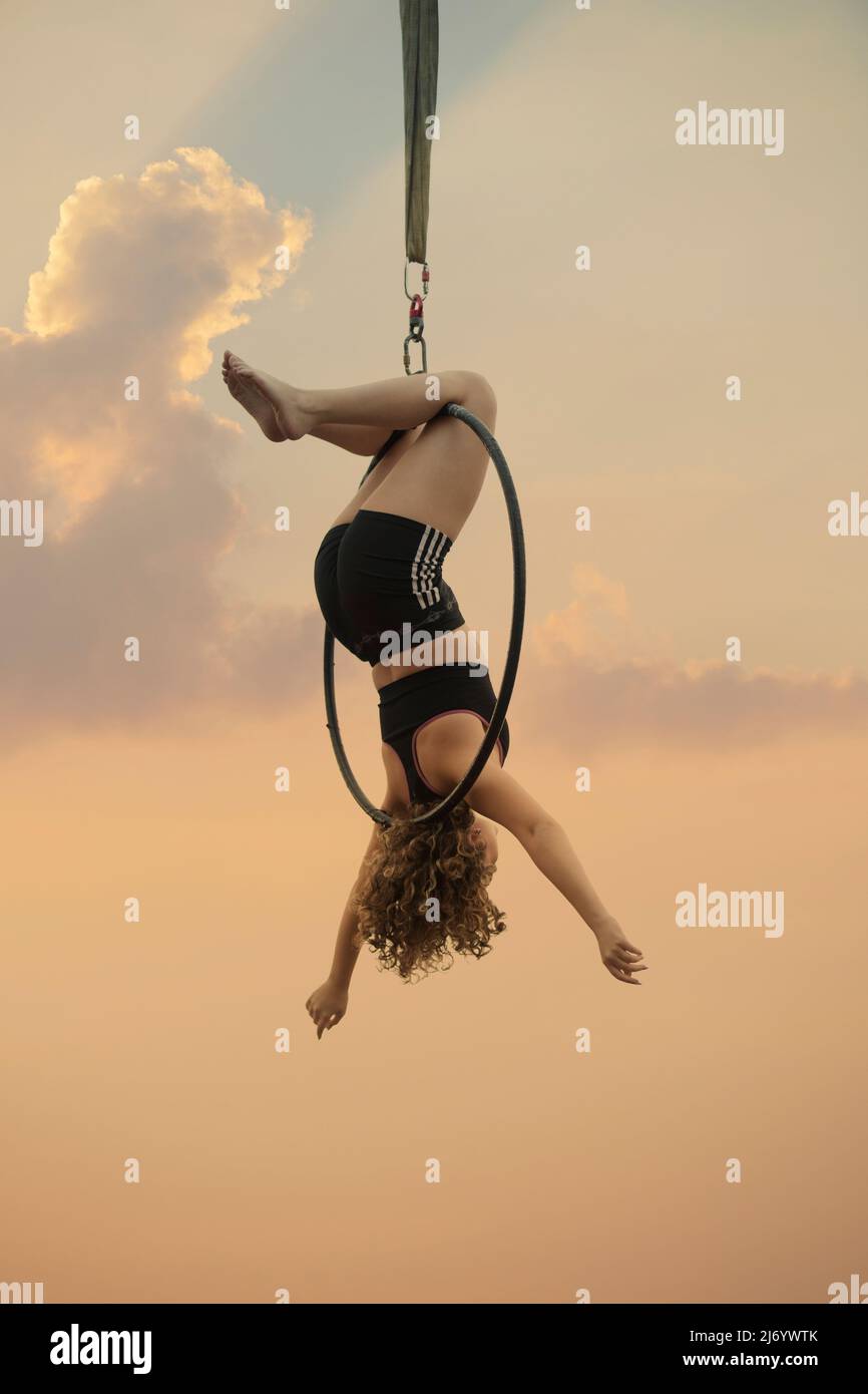 Female aerialist performing on a hoop Stock Photo - Alamy