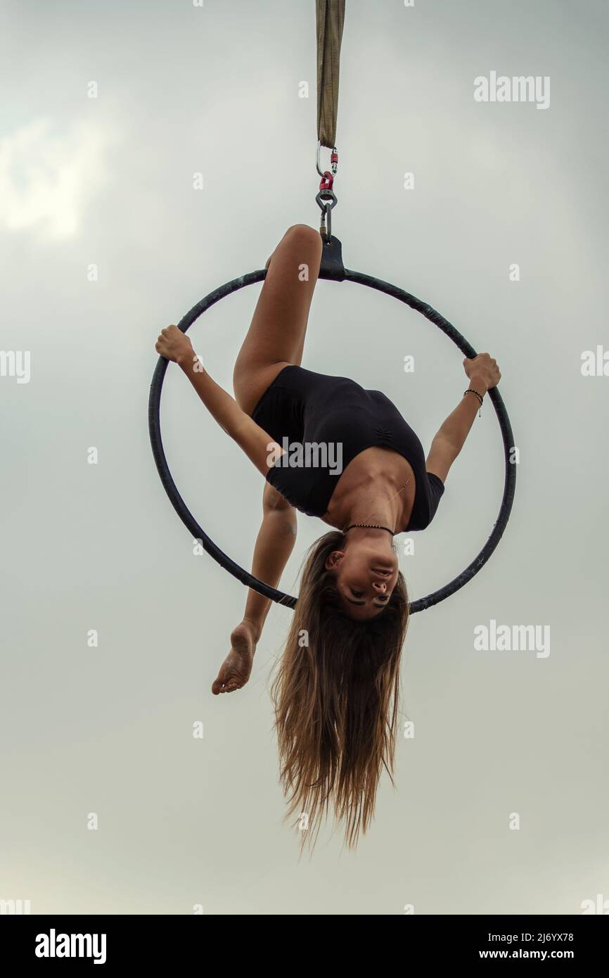 Female aerialist performing on a hoop Stock Photo - Alamy