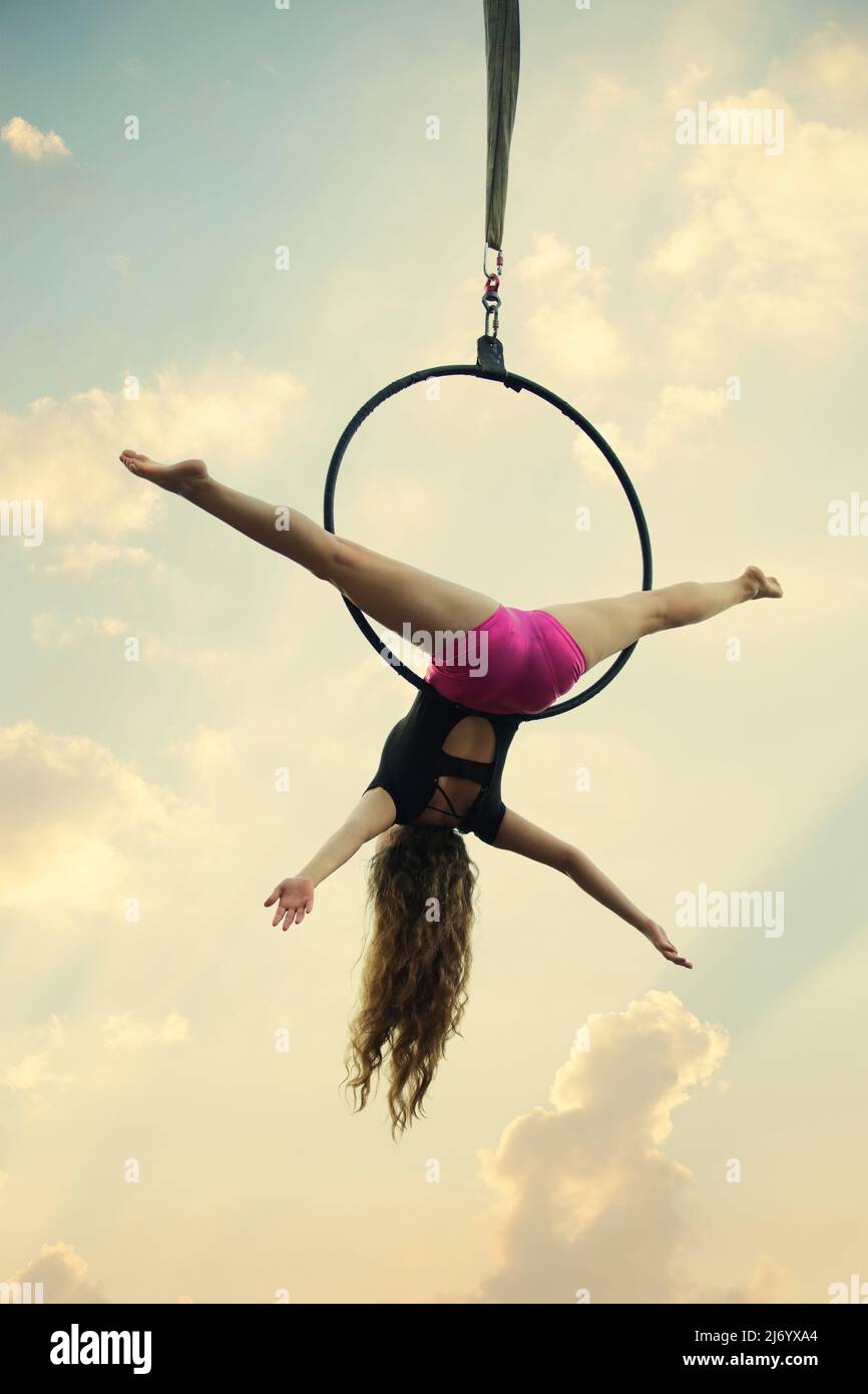 Female aerialist performing on a hoop Stock Photo - Alamy