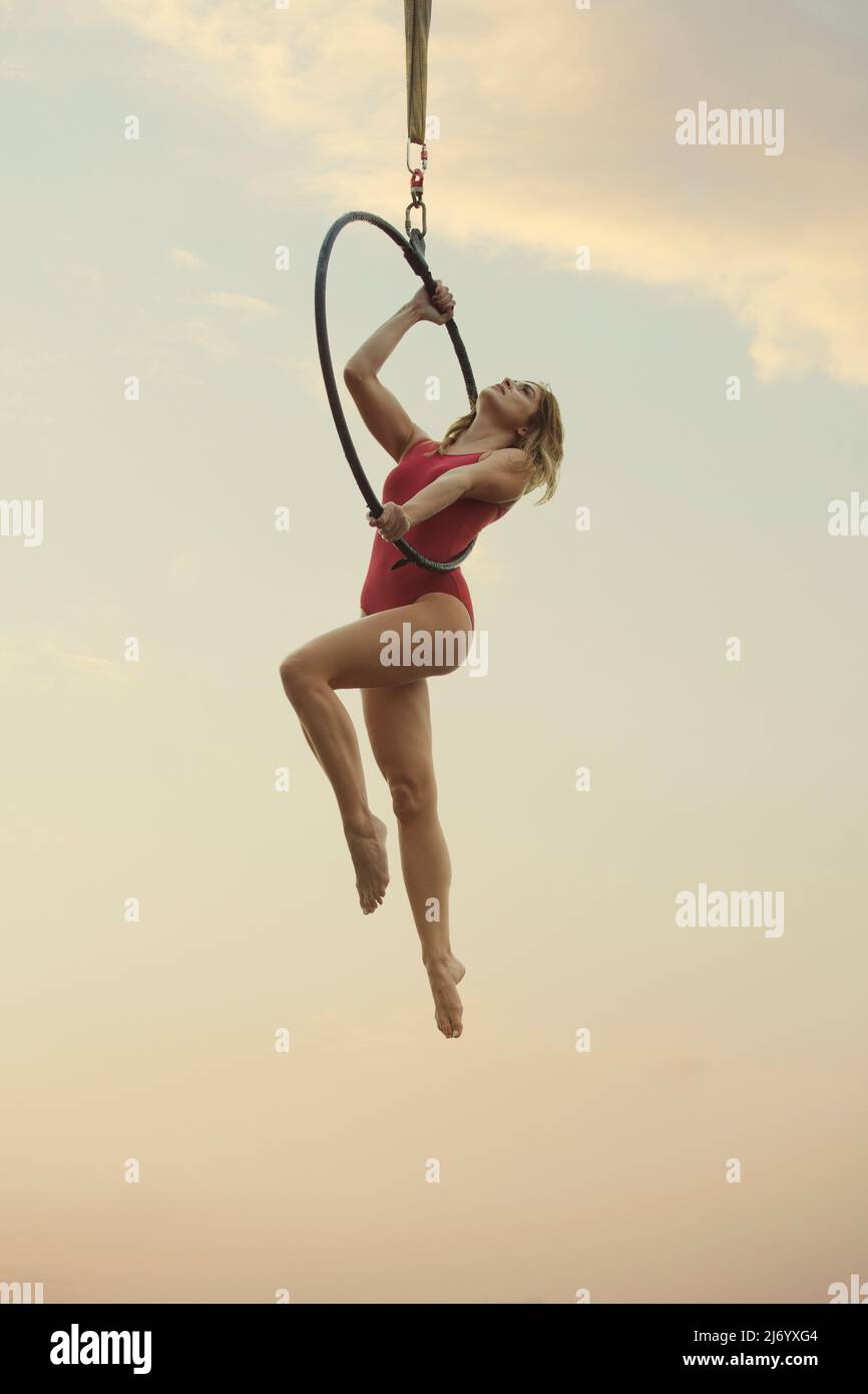 Female aerialist performing on a hoop Stock Photo - Alamy