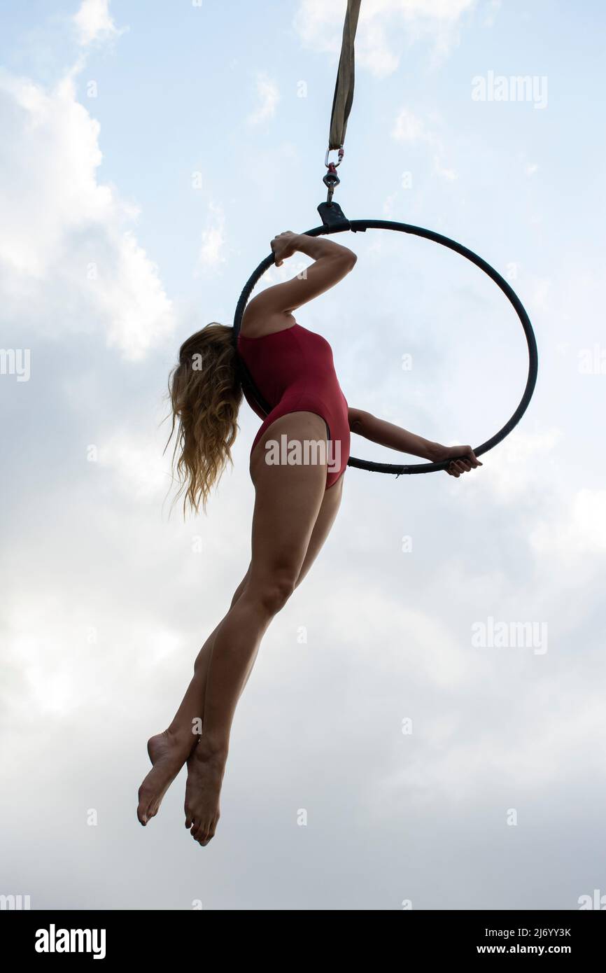 Female aerialist performing on a hoop Stock Photo - Alamy