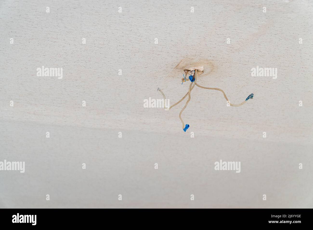 Dangerous bad wiring which hangs on the ceiling Stock Photo - Alamy