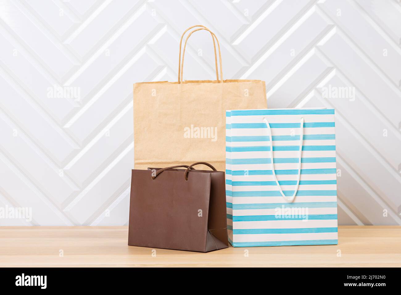 Blank paper carrier bag with handles for shopping, facing front on ...