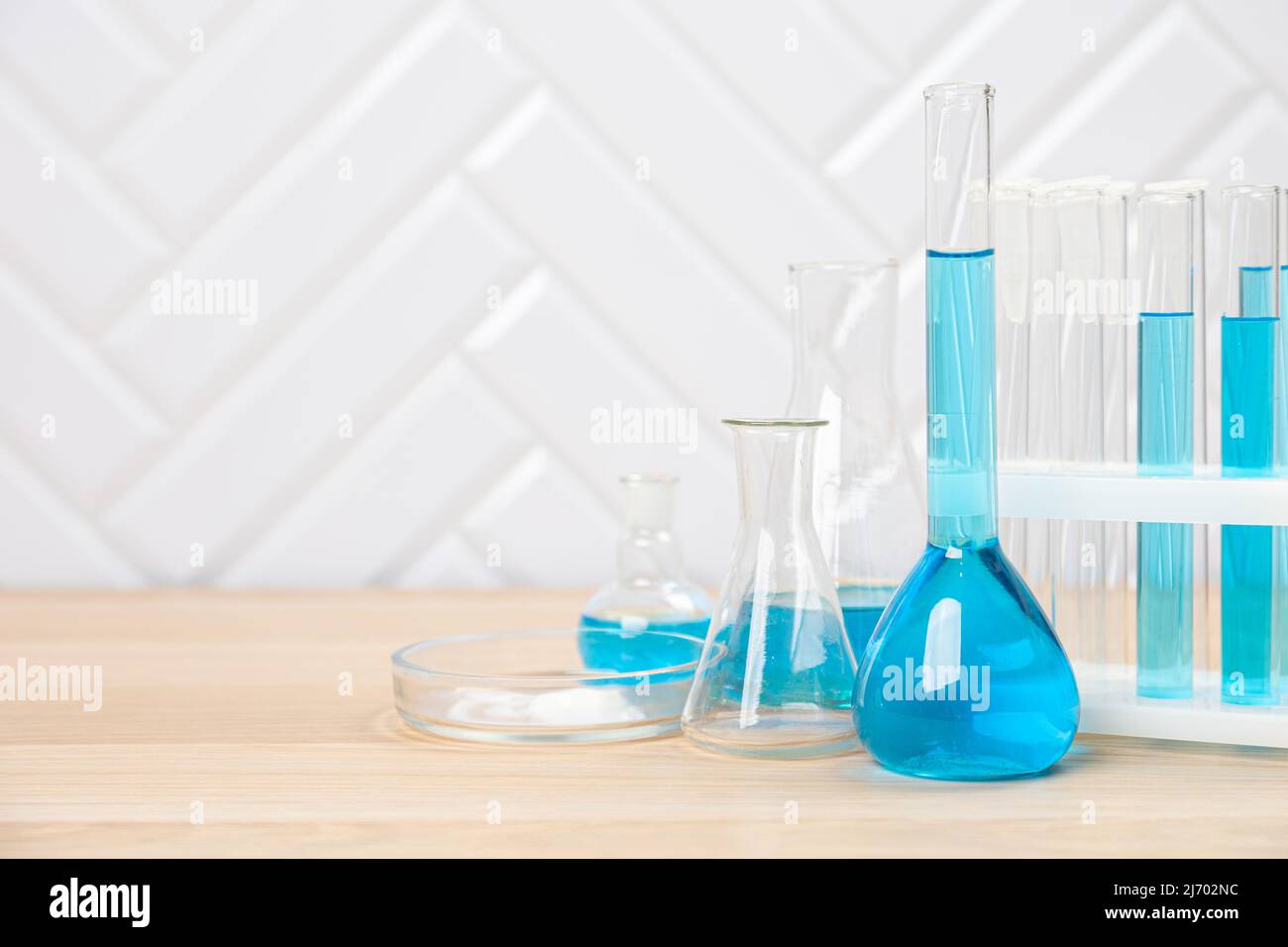 Laboratory glassware with test tubes. flasks, dropper, petri dishes ...