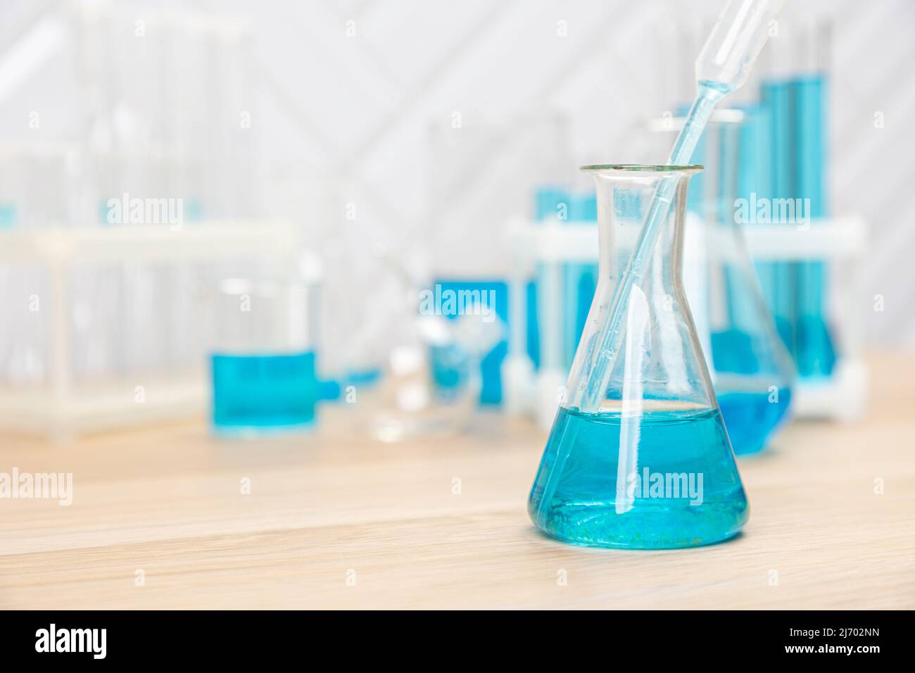 Laboratory glassware with blue liquid in a test tube. scientific ...