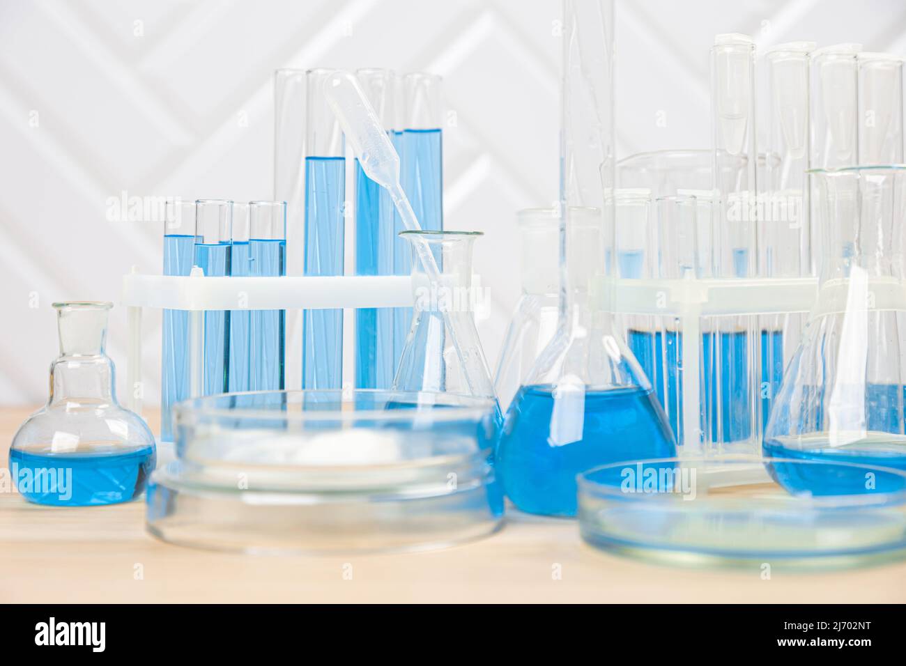 Laboratory glassware with blue liquid in a test tube. scientific ...