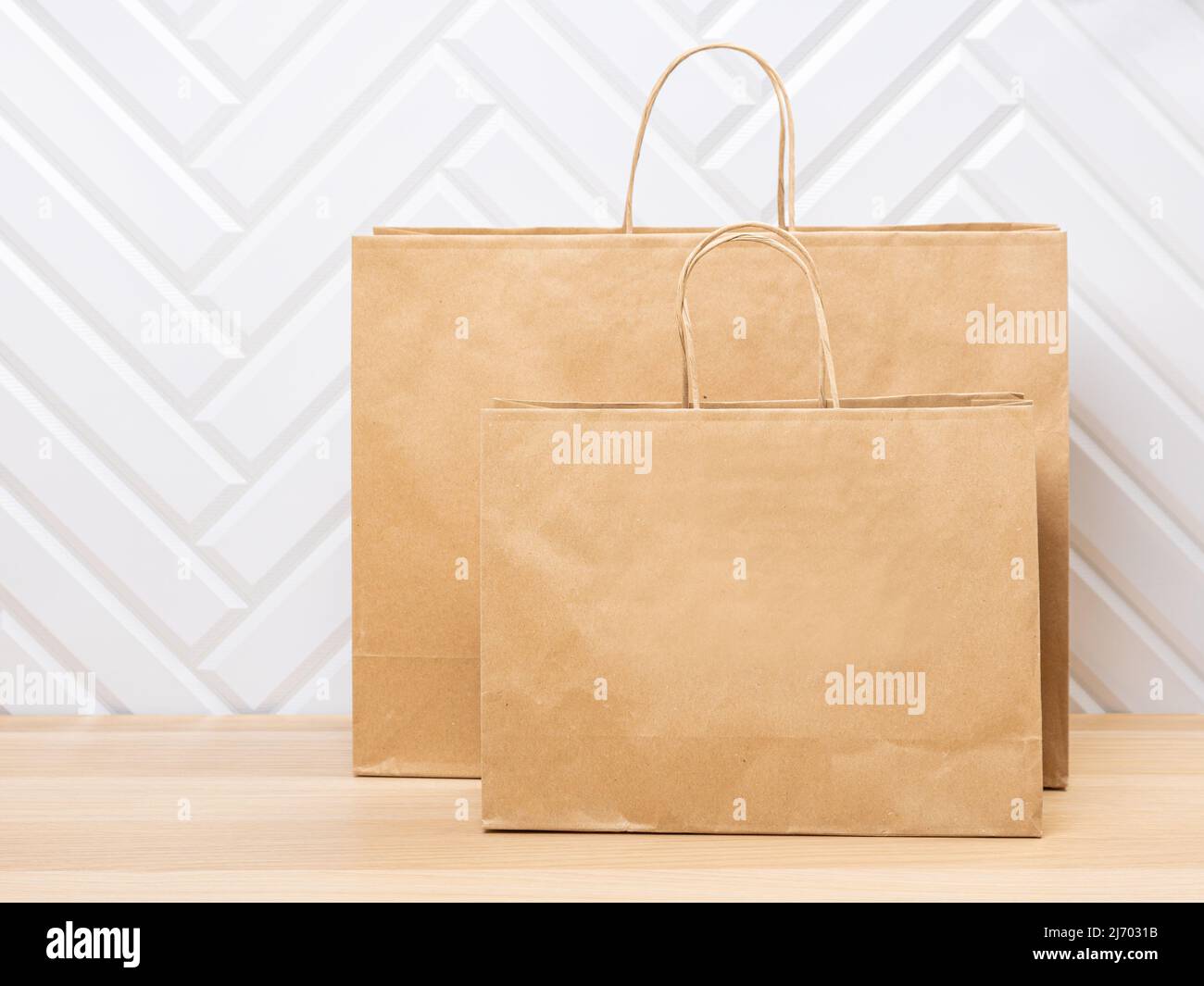 Blank paper carrier bag with handles for shopping, facing front on ...