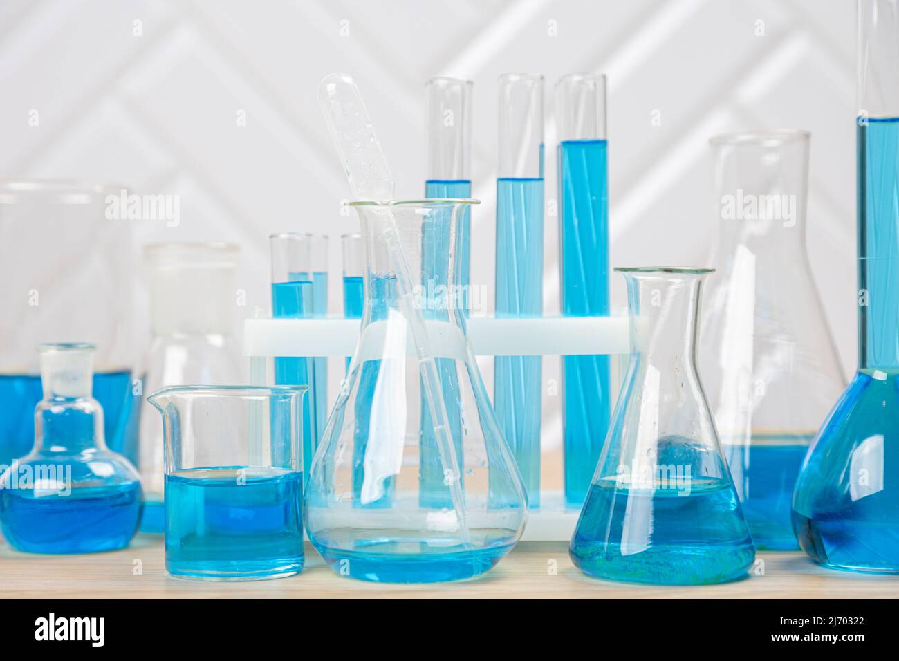 Laboratory glassware with blue liquid in a test tube. scientific ...