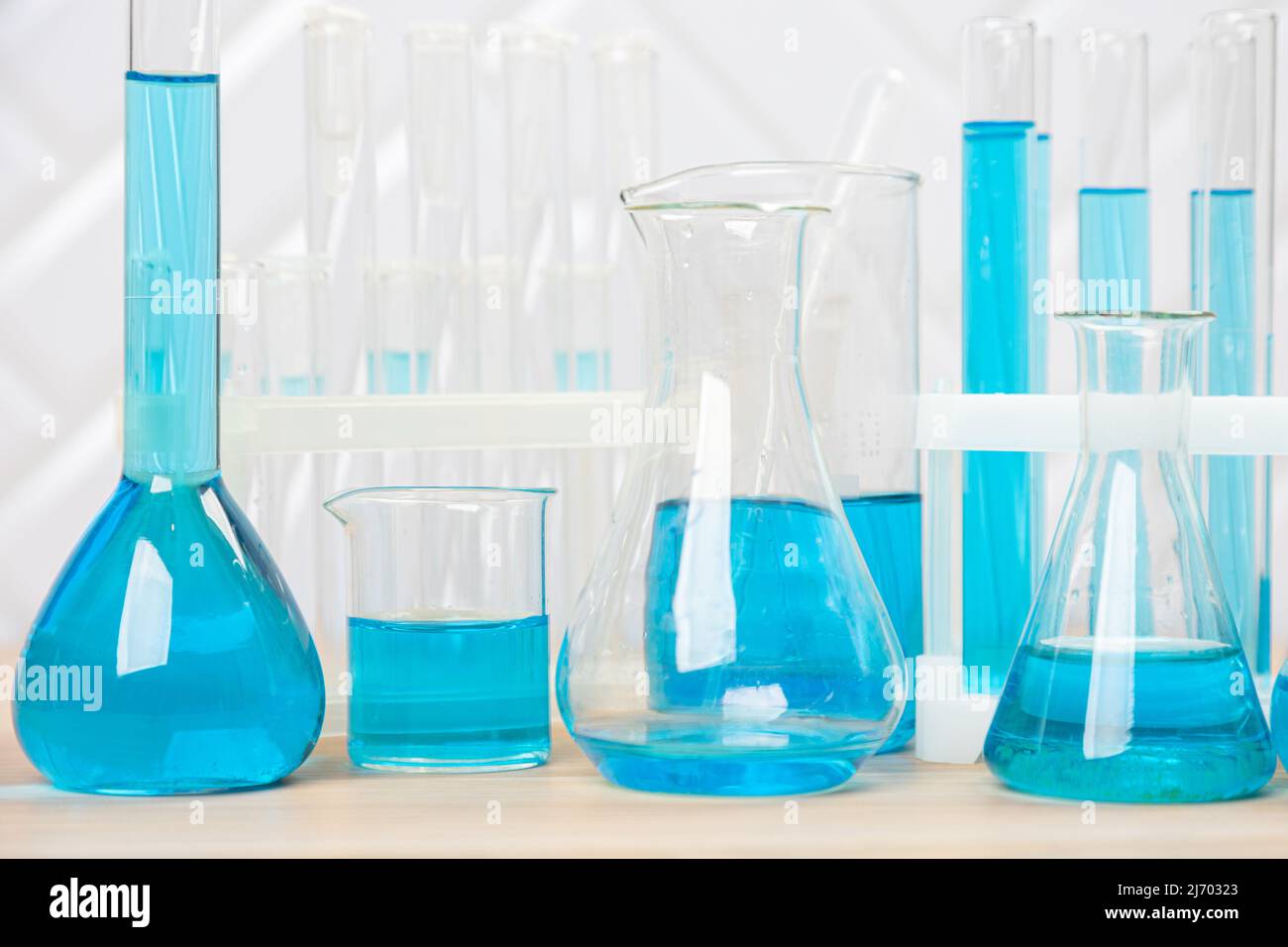 Laboratory glassware with blue liquid in a test tube. scientific ...