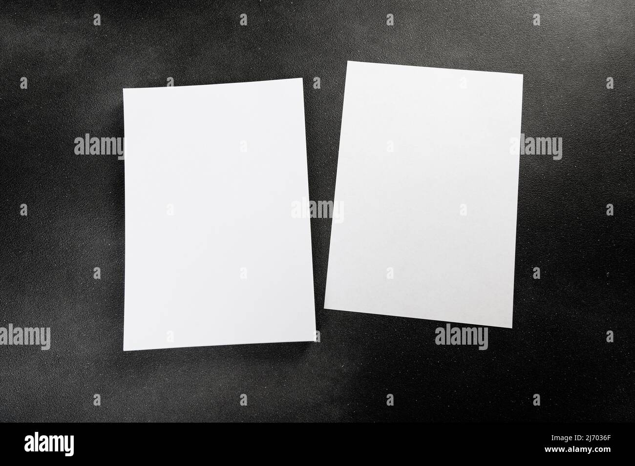 Blank flyer poster A4 paper isolated on dark gray to replace your ...
