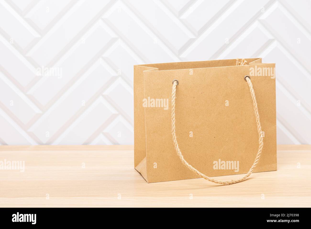 Blank paper carrier bag with handles for shopping, facing front on ...