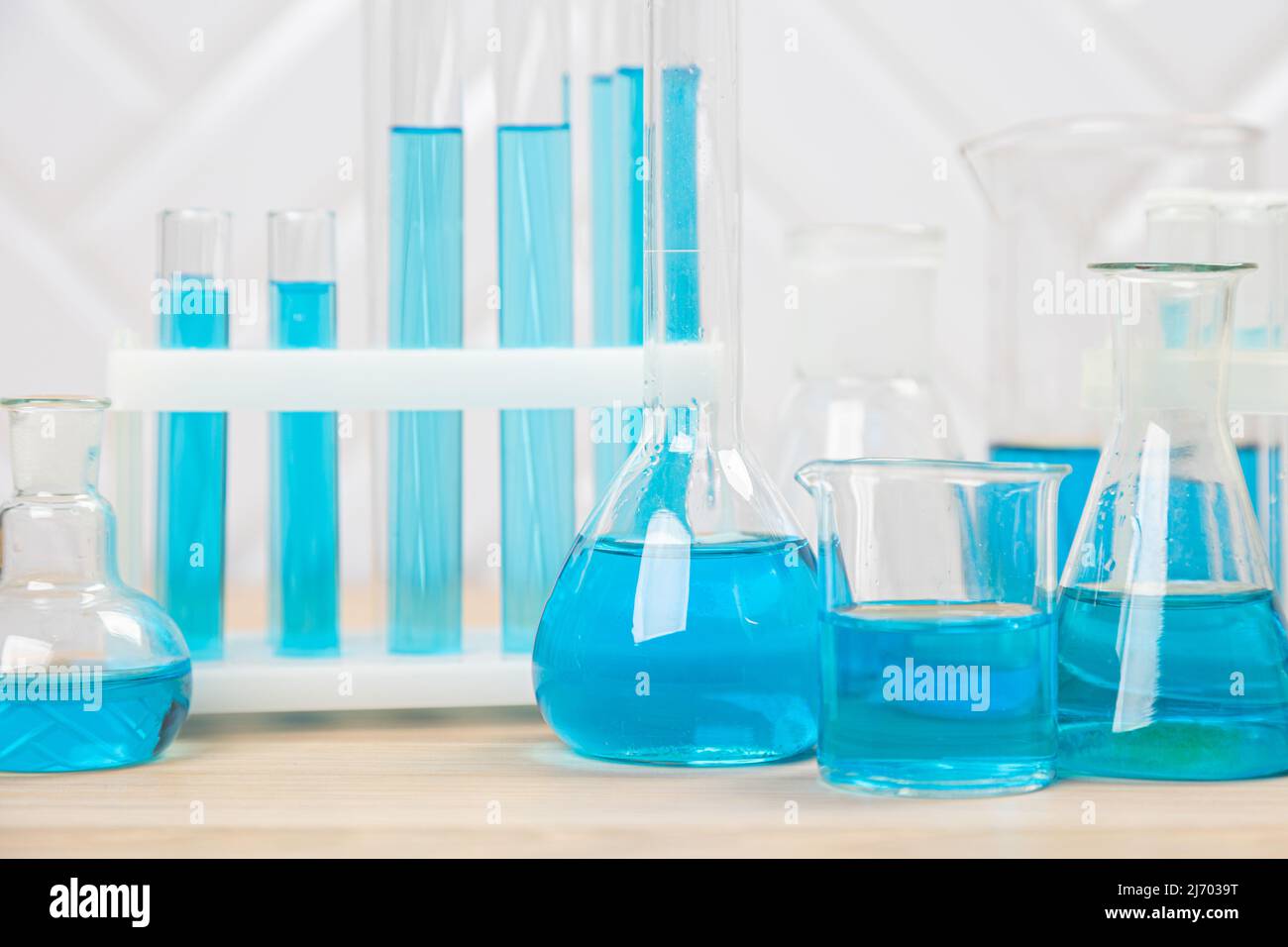 Laboratory glassware with blue liquid in a test tube. scientific ...