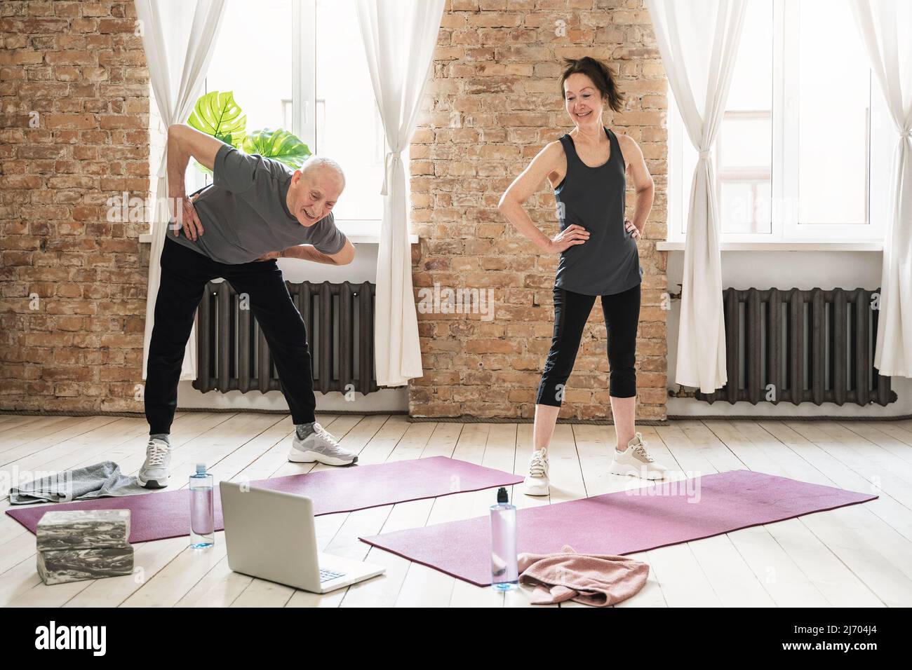 Active elderly people during fitness workout with an online class at ...