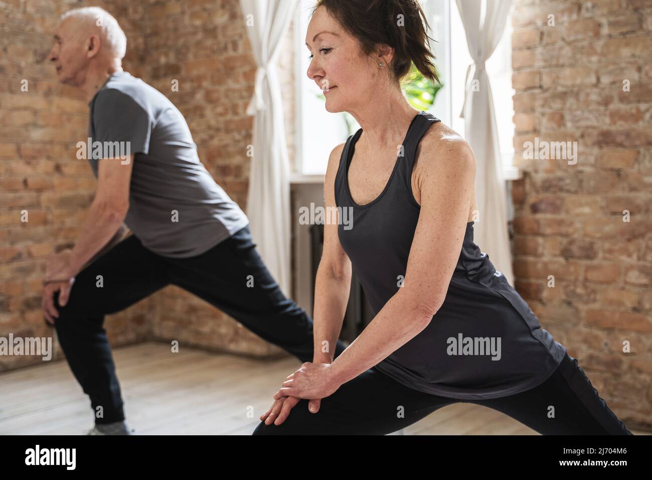 Two elderly people during fitness workout at home Stock Photo - Alamy