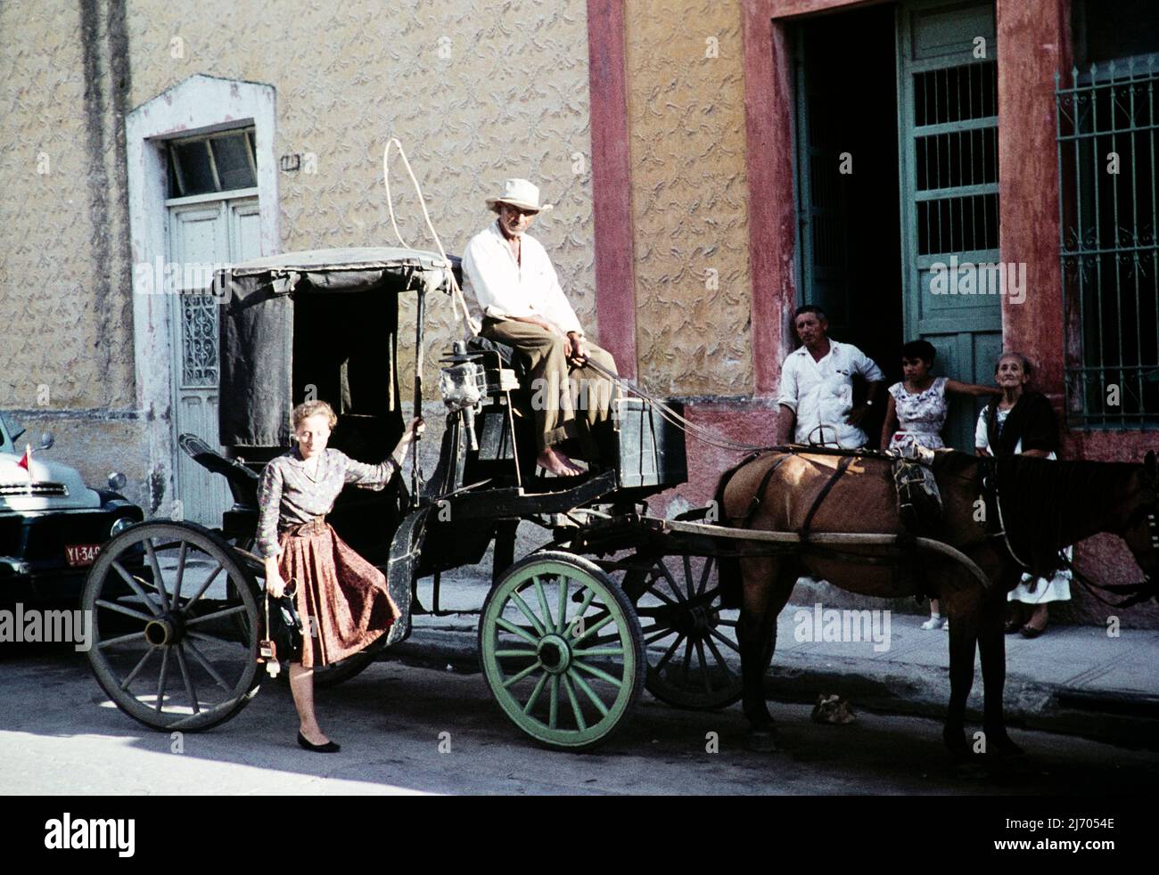 Female tourist standiung by Surrey horse drawn carriage tourist tours ...