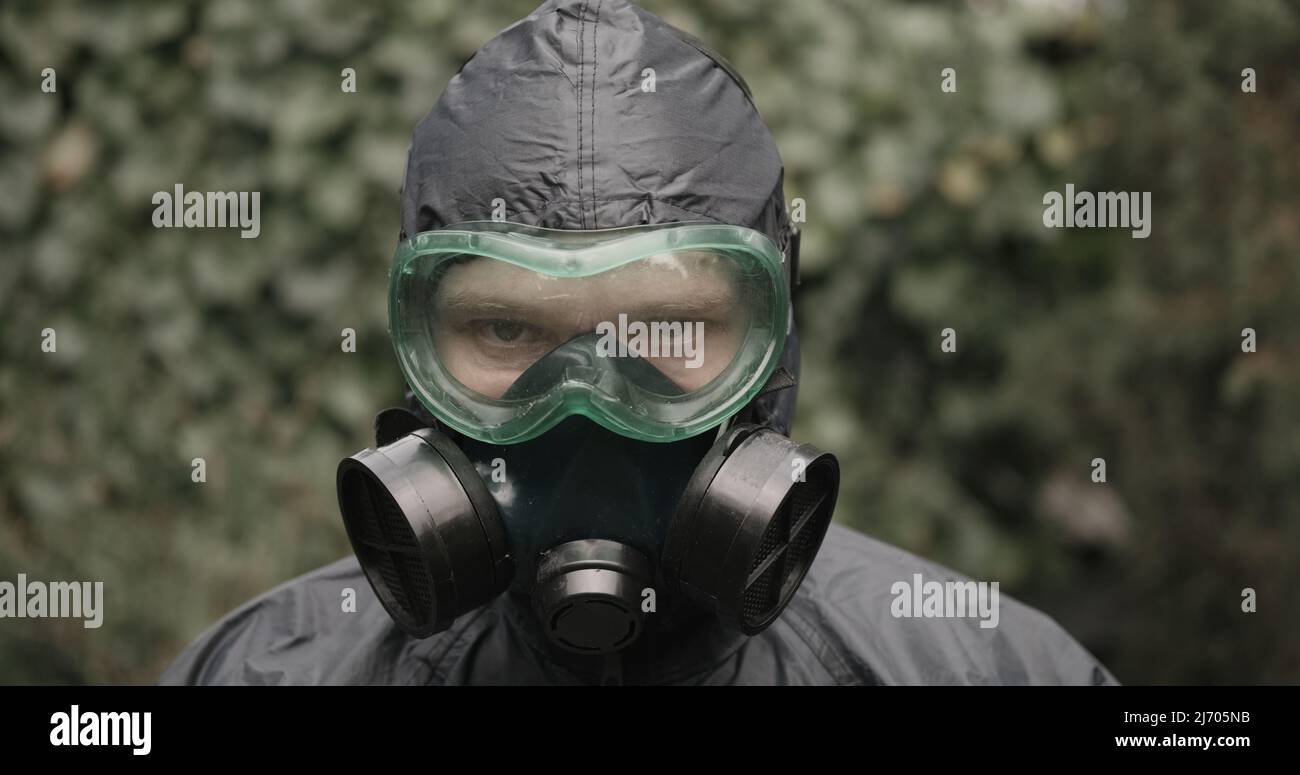 Man in chemical protection suit, respirator and glasses close-up Stock ...