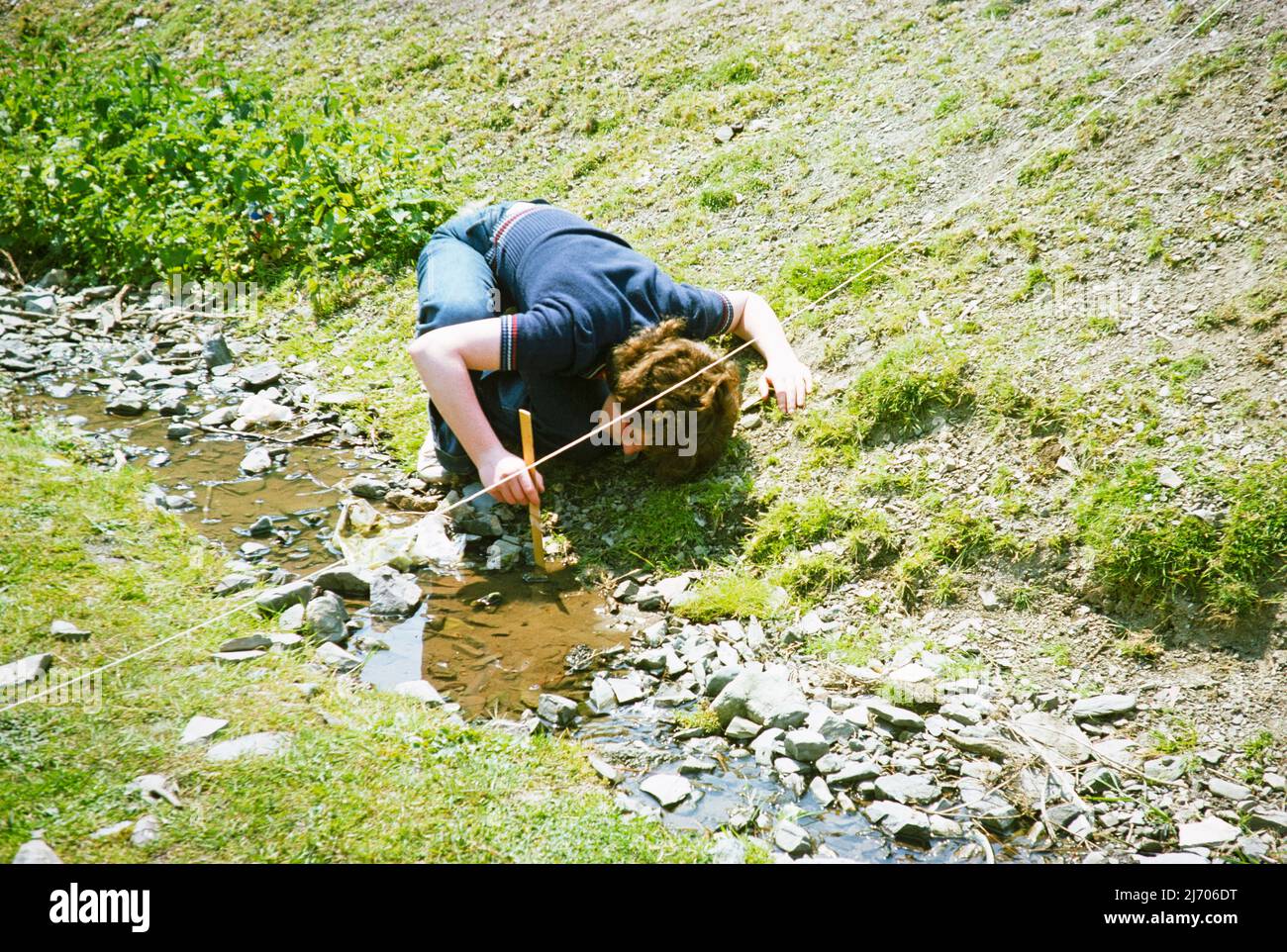 Female secondary school student engaged in geography fieldwork, UK ...
