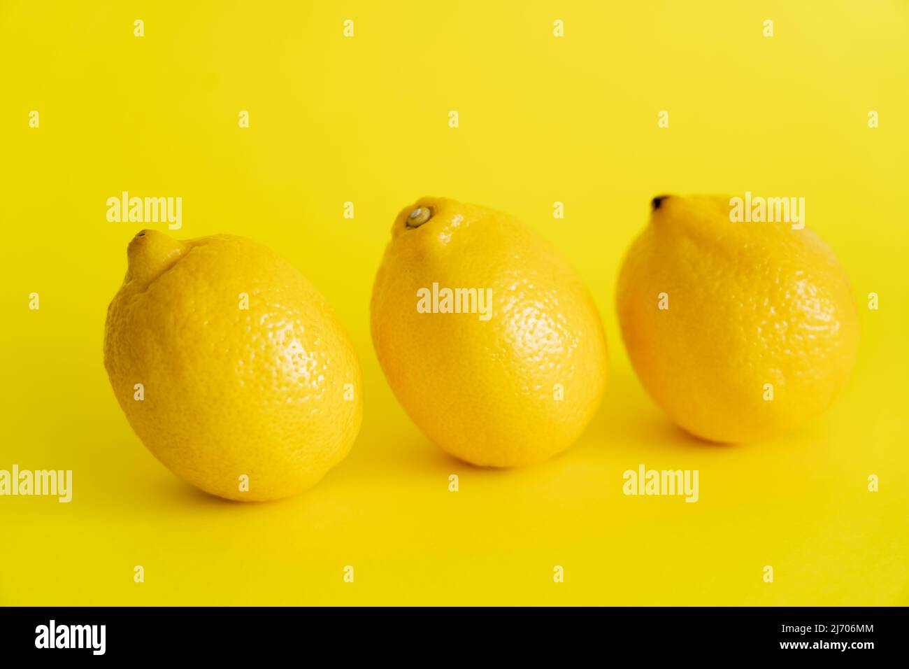Organic lemons on yellow surface with copy space Stock Photo - Alamy