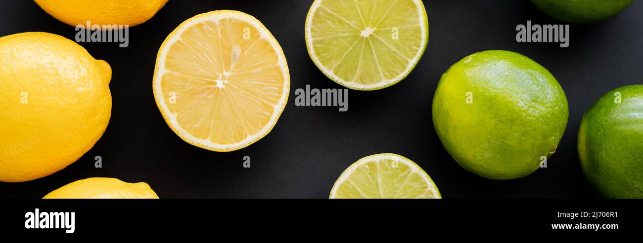 Top view of bright limes and lemons on black background, banner Stock ...