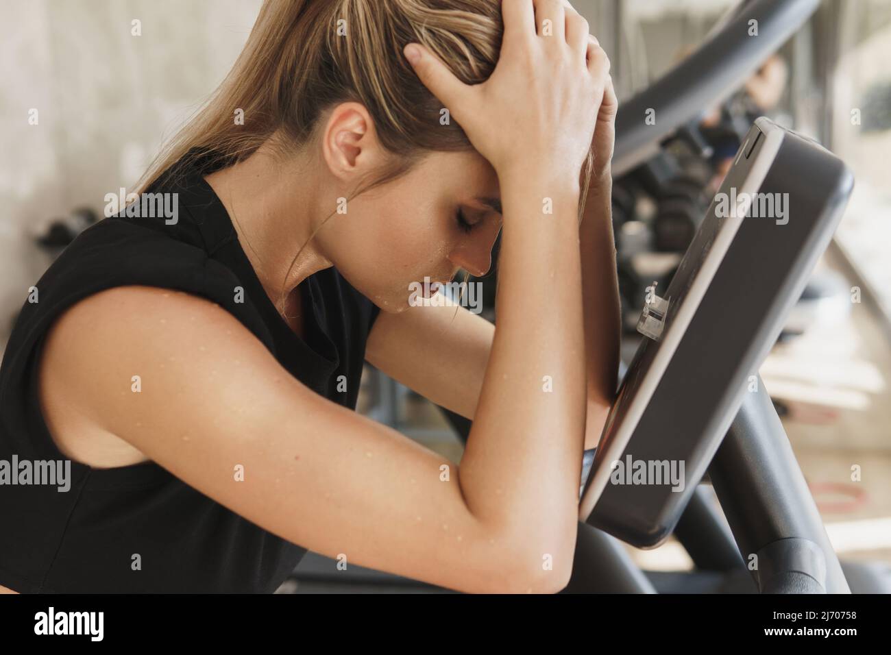 Exhausted woman after her fitness workout in the gym Stock Photo - Alamy