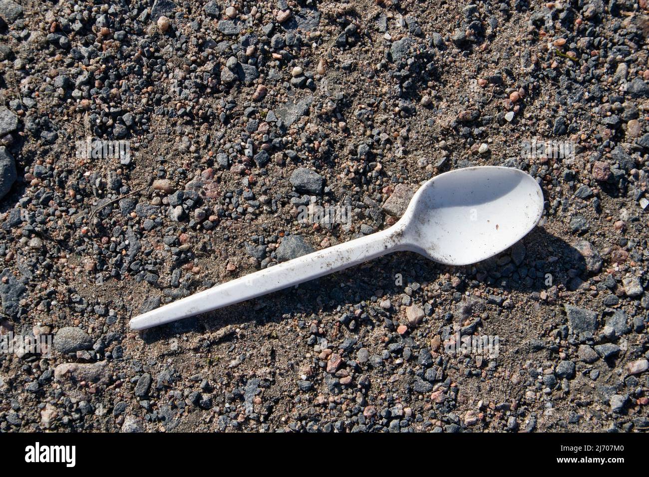 white plastic spoon on the ground Stock Photo - Alamy