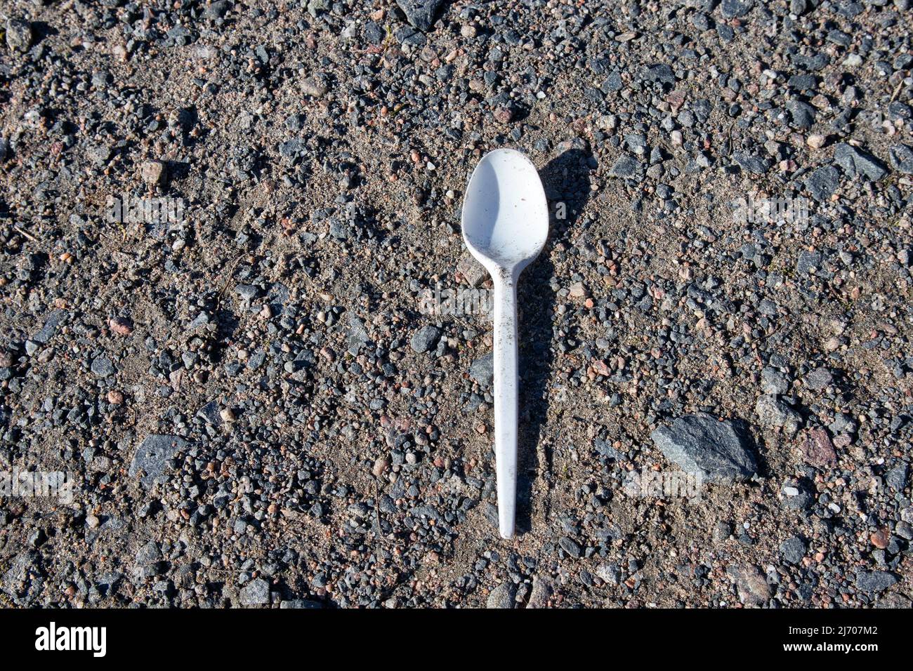 white plastic spoon on the ground Stock Photo - Alamy