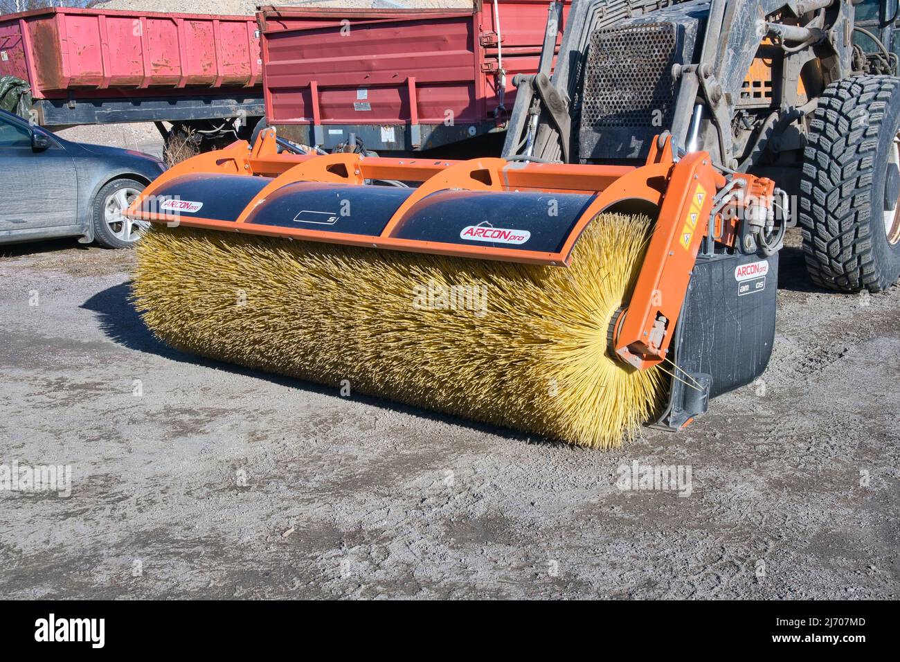 Rotating industrial brush of a street cleaning tractor Stock Photo - Alamy