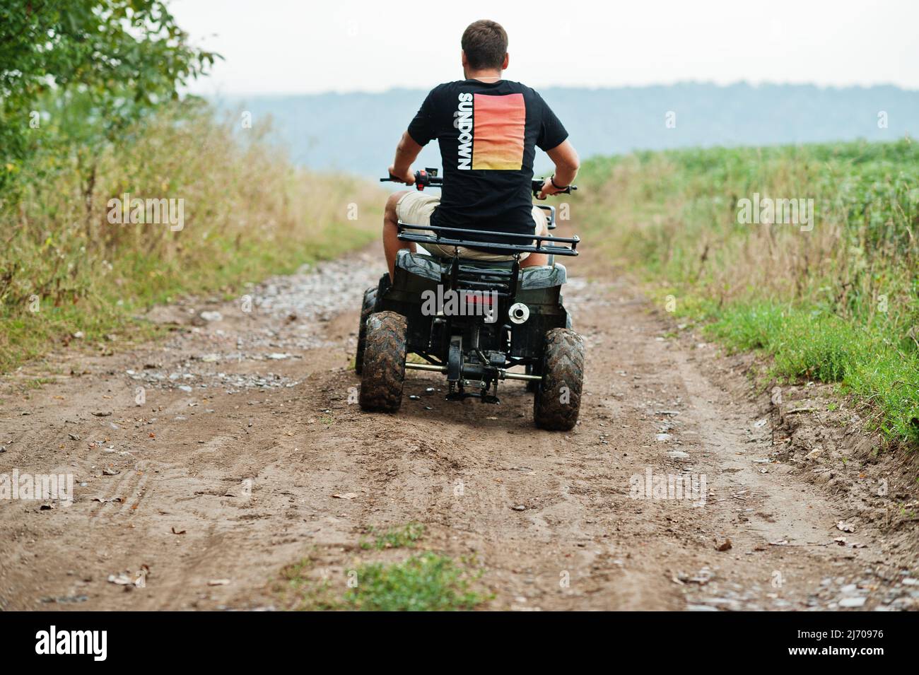 Man driving four-wheller ATV quad bike Stock Photo - Alamy
