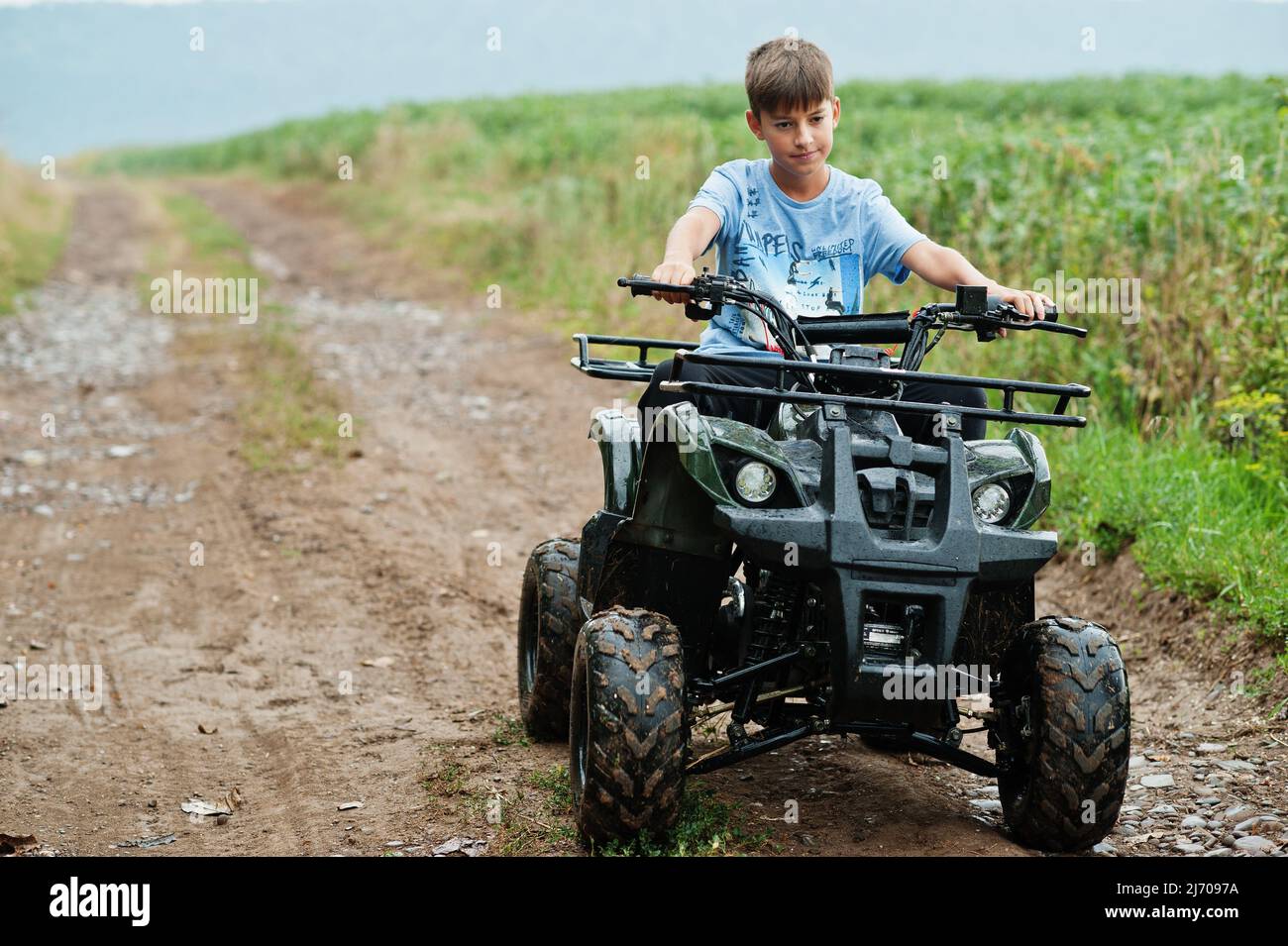 Boy drive four-wheller ATV quad bike Stock Photo - Alamy