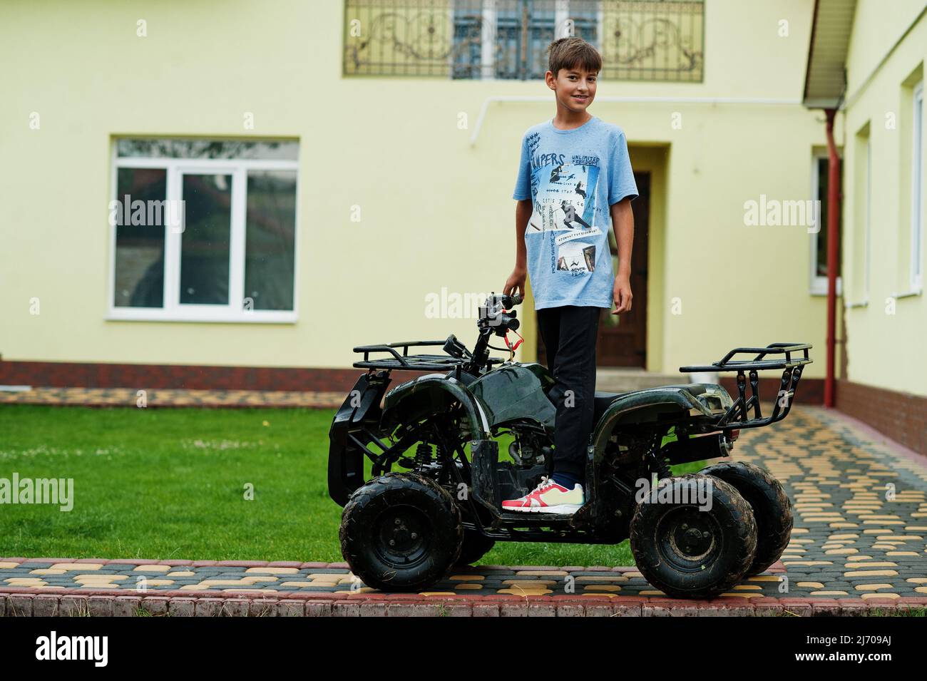 Boy in four-wheller ATV quad bike Stock Photo - Alamy