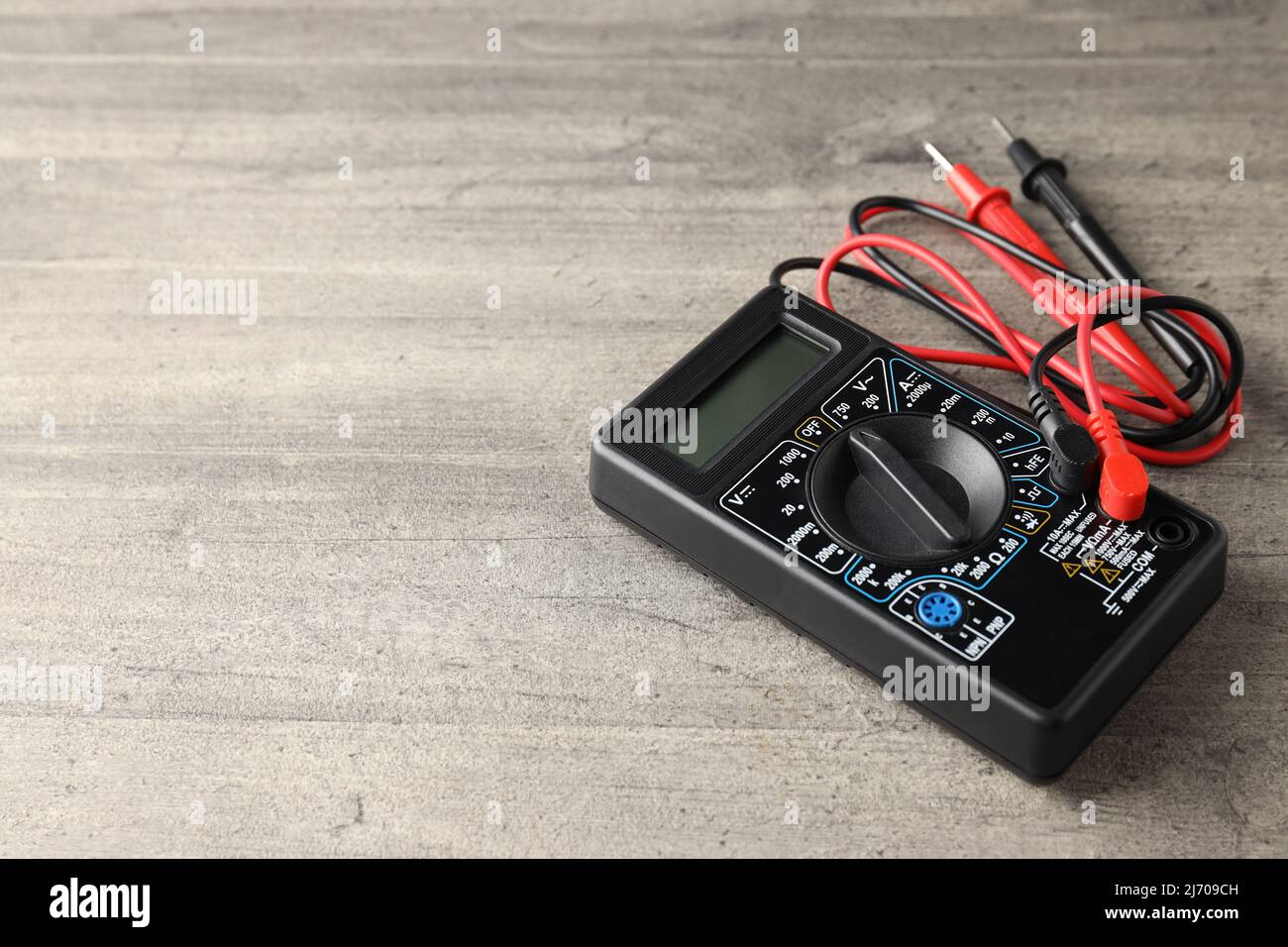One black multimeter on gray textured background Stock Photo - Alamy