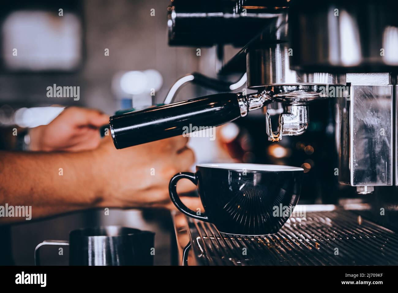 Barista making coffee with coffee machine in cafe Stock Photo - Alamy