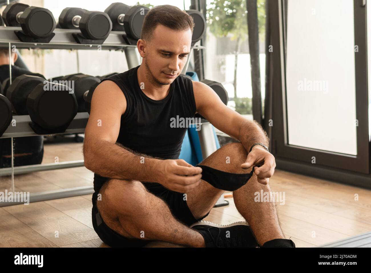 Young athletic man wearing a prevention face mask during his workout in ...