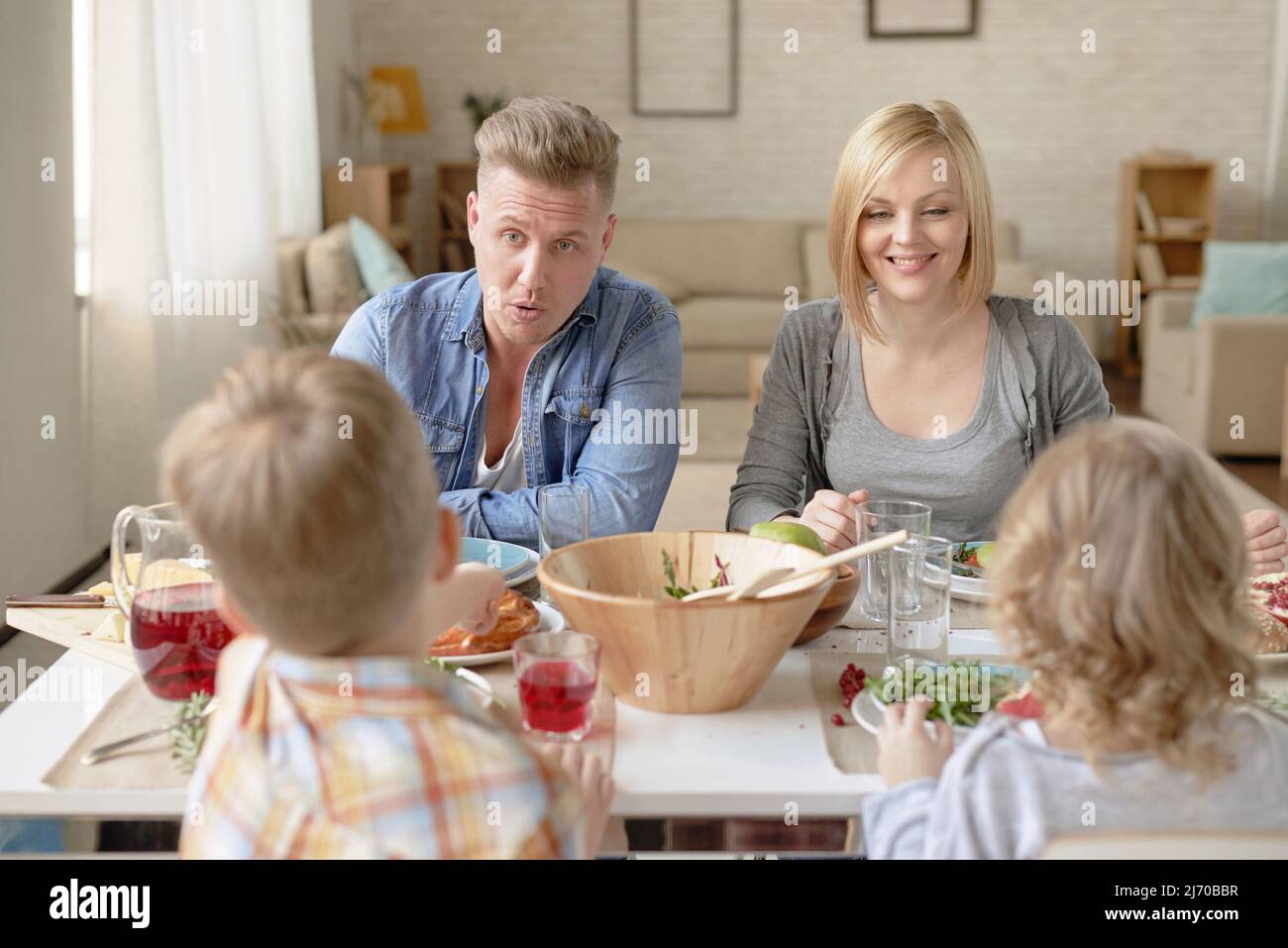 Mother talking to kids at dinner table hi-res stock photography and ...