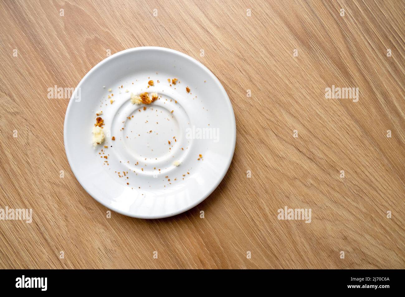 White ceramic dessert plate with pastry leftover, crumbs, top view ...