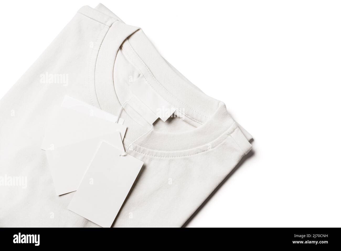 T-shirt with blank paper labels on white background Stock Photo - Alamy