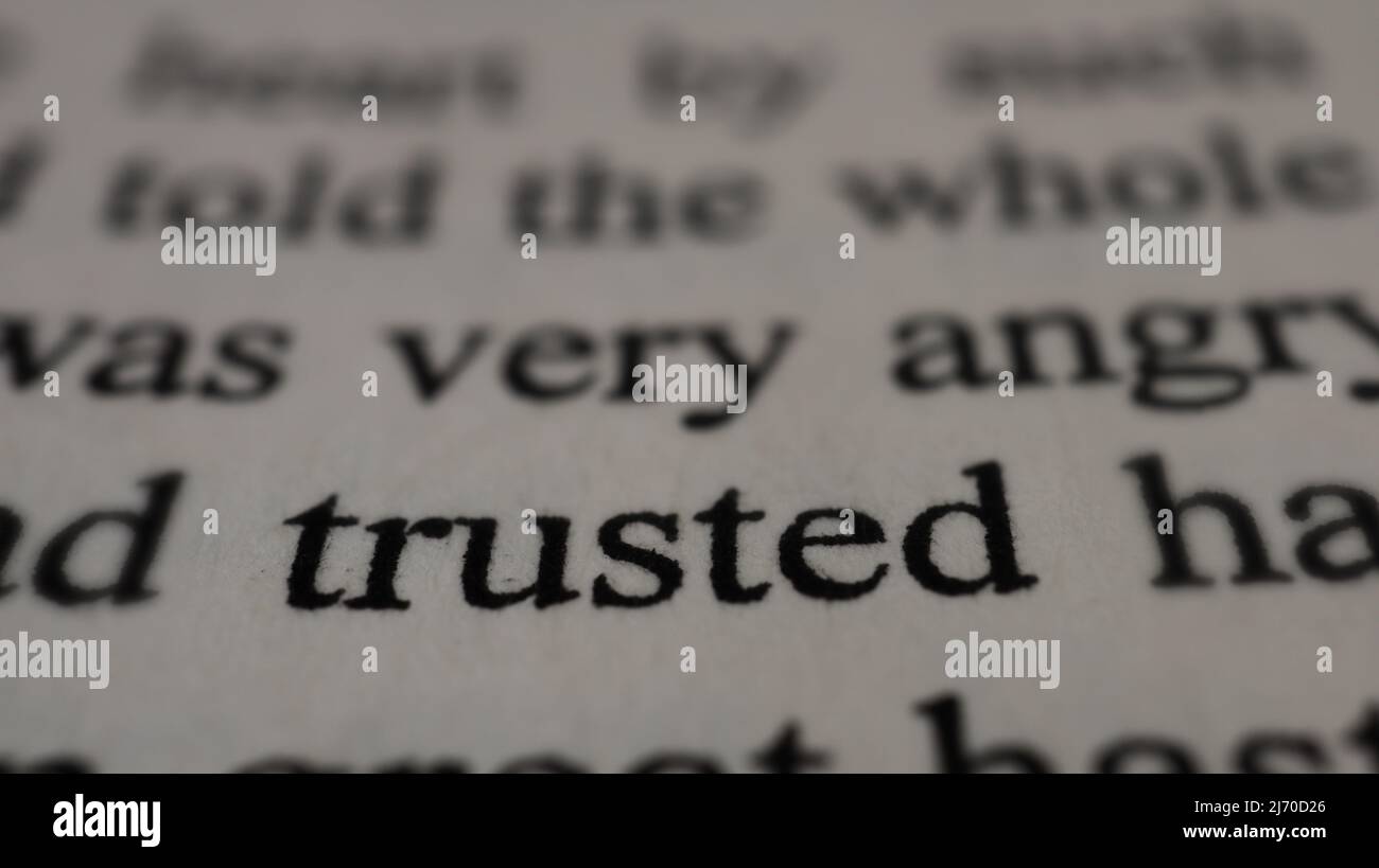 Trusted text in open book page, selective focus, close up, macro shot ...