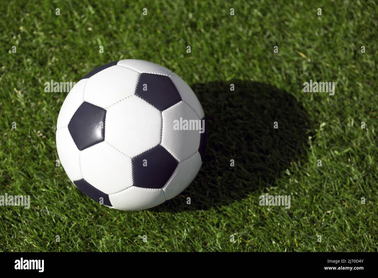 Classic soccer ball on grass field. View from above on retroc classic ...