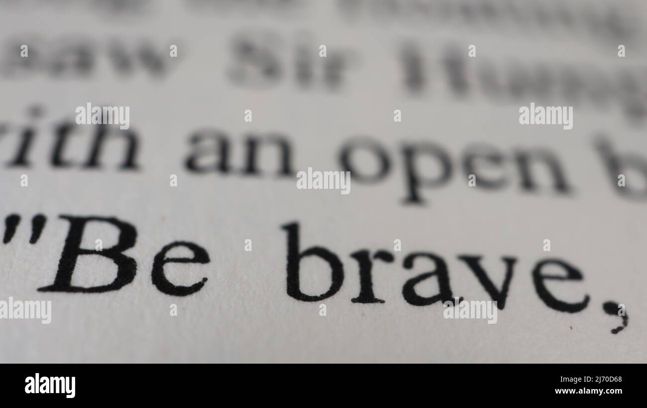 Be brave text in open book page, selective focus, close up, macro shot ...